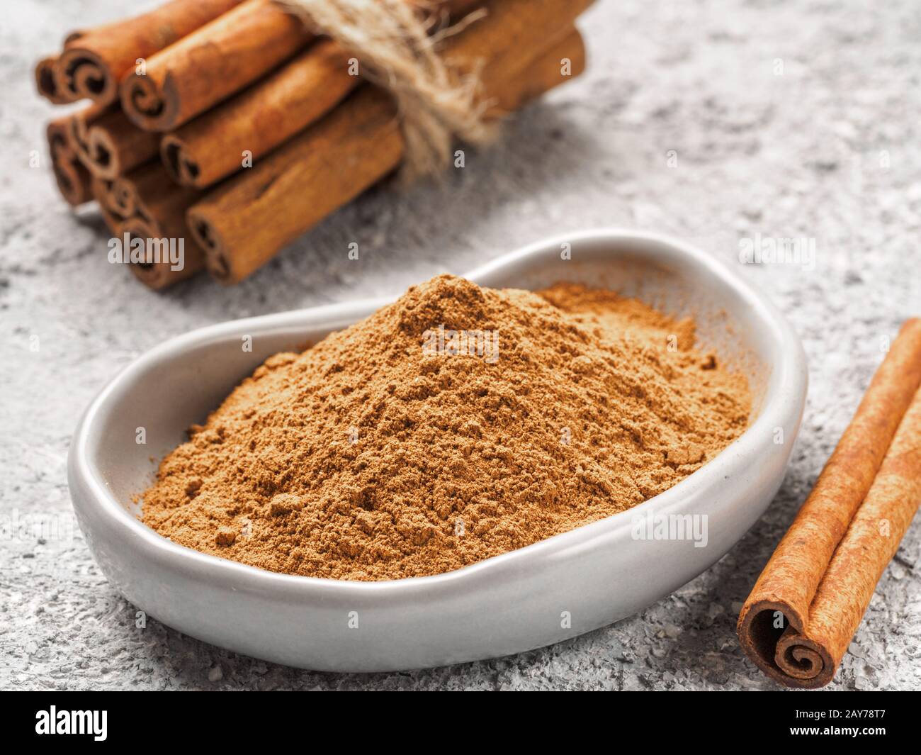 Ground cinnamon on gray background Stock Photo - Alamy