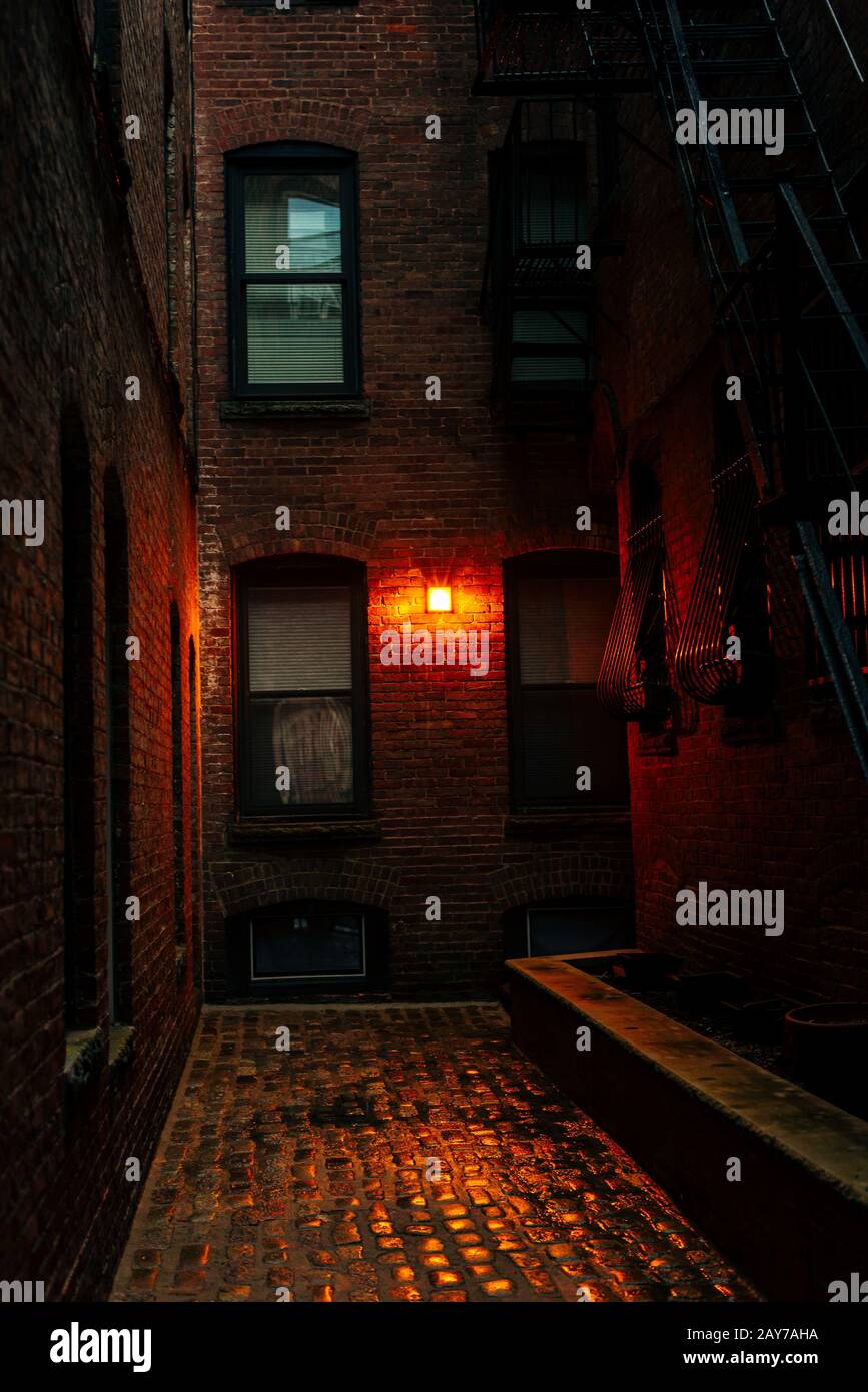 A dark creepy narrow boston alley at night Stock Photo - Alamy