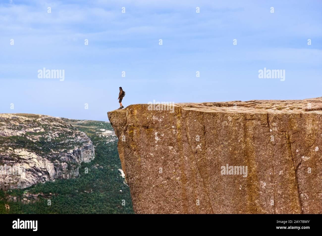 Lonely man standing on cliff Preikestolen in fjord Lysefjord - Norway ...