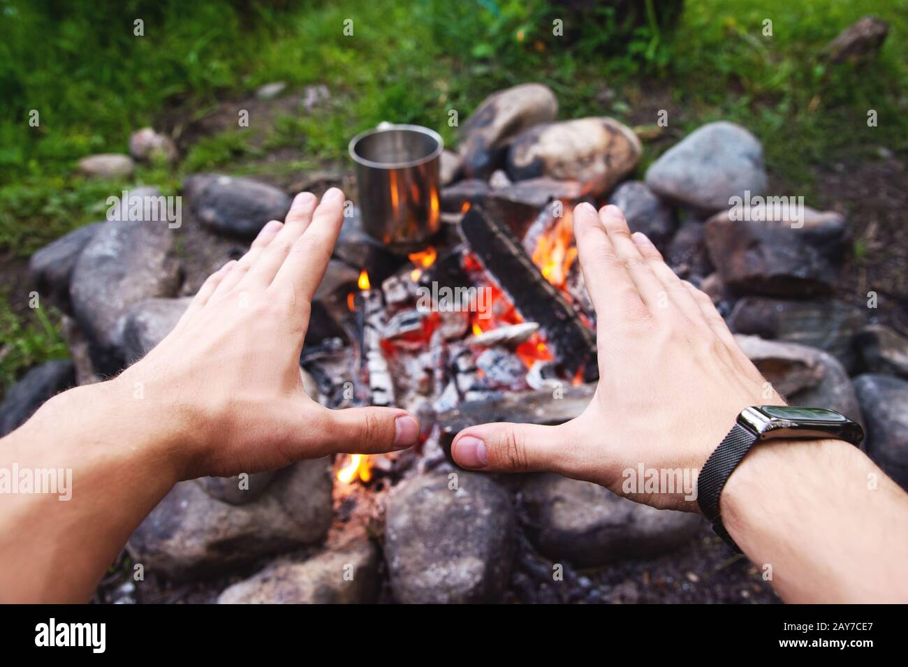 Men's hands are warming around the fire Stock Photo - Alamy