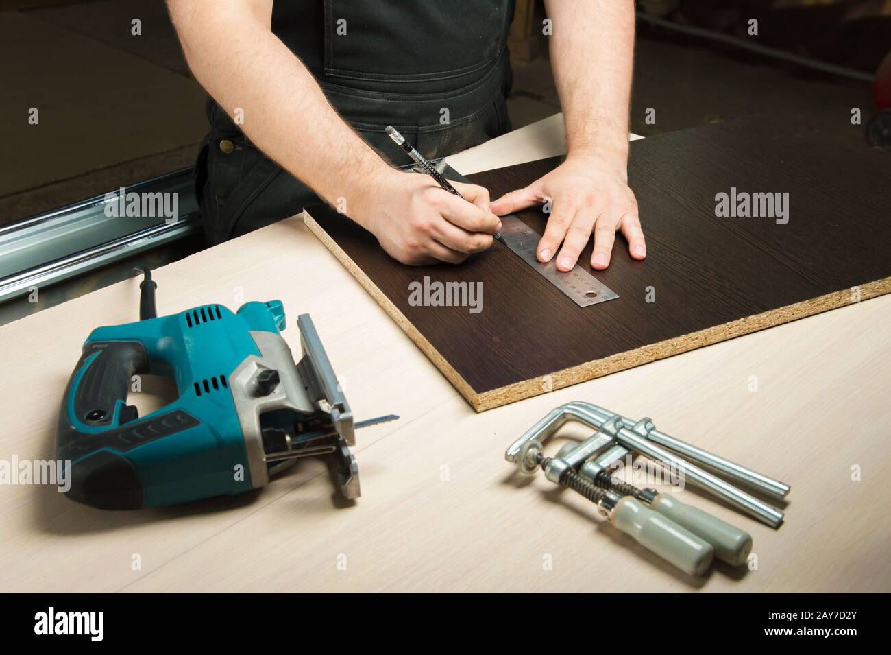 Male hands draw a pencil on the ruler Stock Photo - Alamy