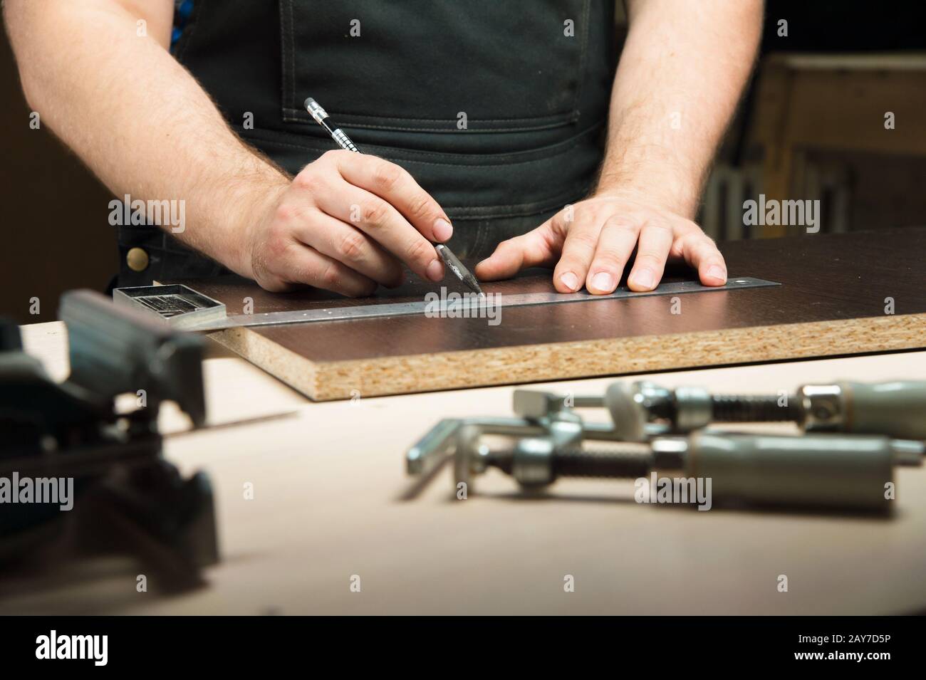 Male hands draw a pencil on the ruler Stock Photo - Alamy