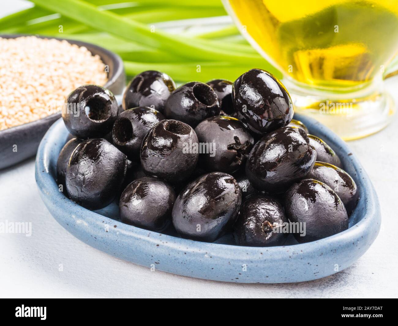 black olives in blue plate Stock Photo - Alamy