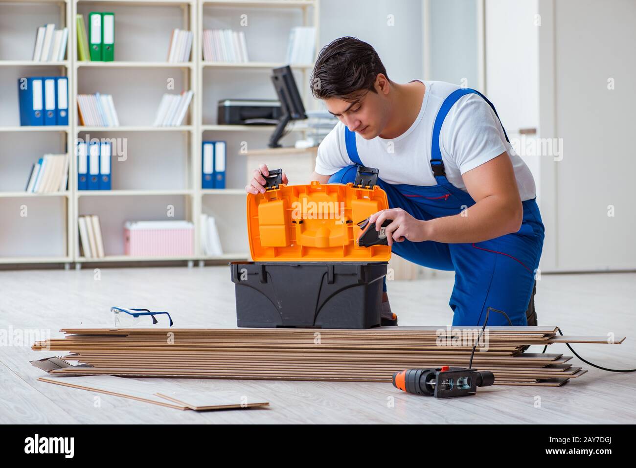 Young worker working on floor laminate tiles Stock Photo - Alamy