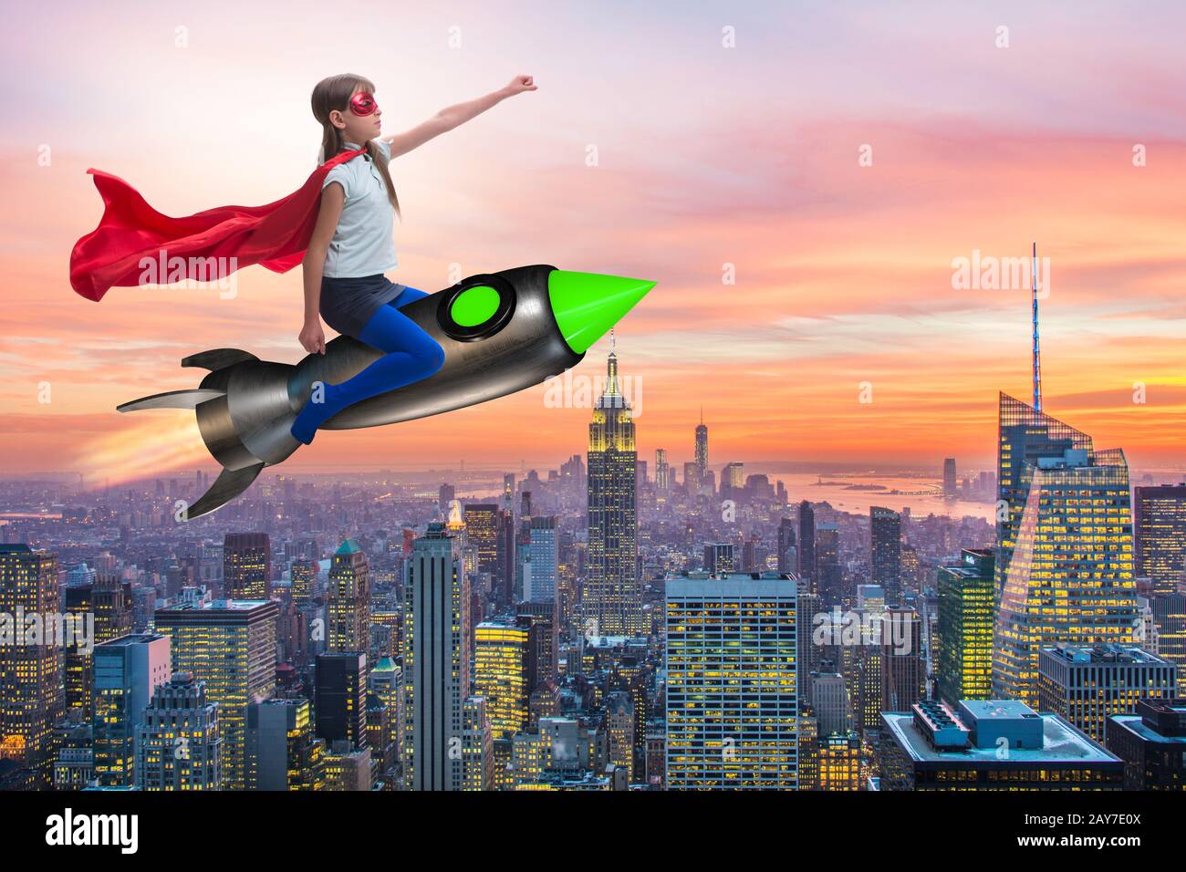 Little girl flying rocket in superhero concept Stock Photo - Alamy