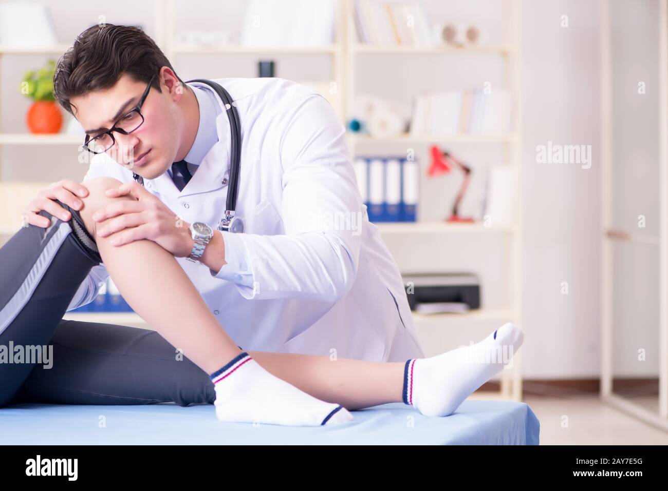 Man doctor taking care of sports injury Stock Photo - Alamy