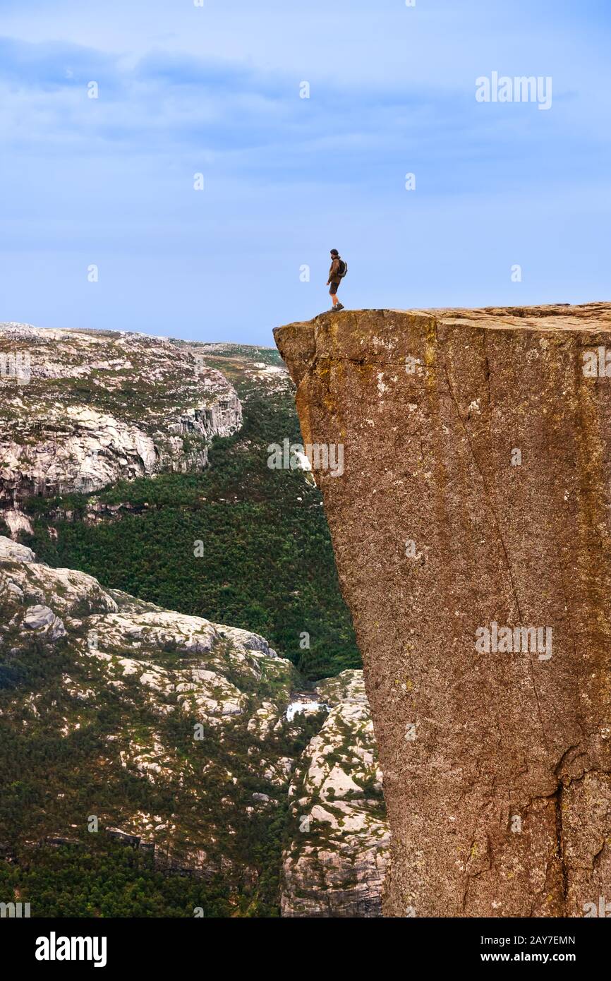 Lonely man standing on cliff Preikestolen in fjord Lysefjord - Norway ...