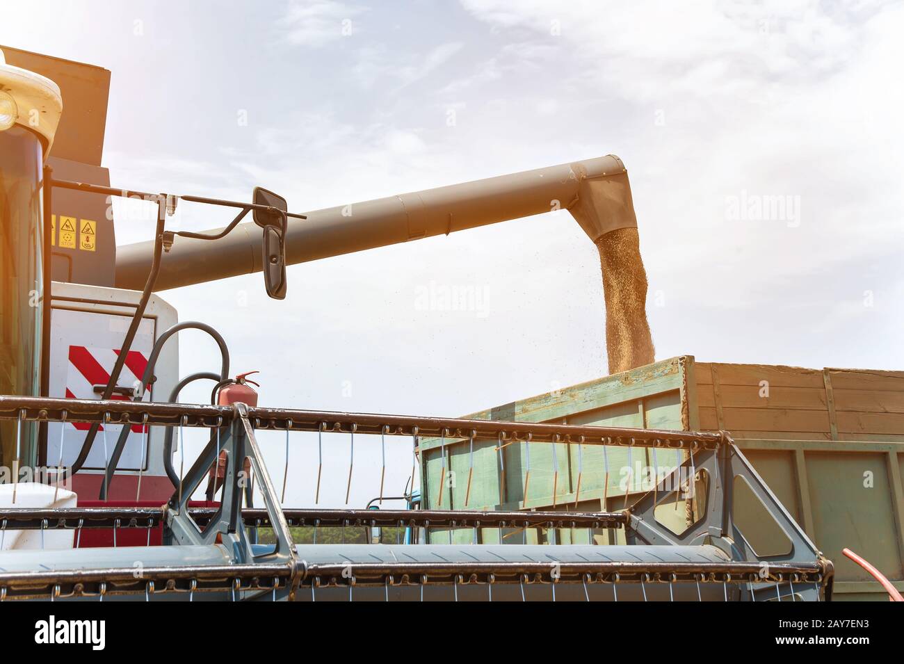 Combine harvester in action on wheat field, unloading grains Stock ...