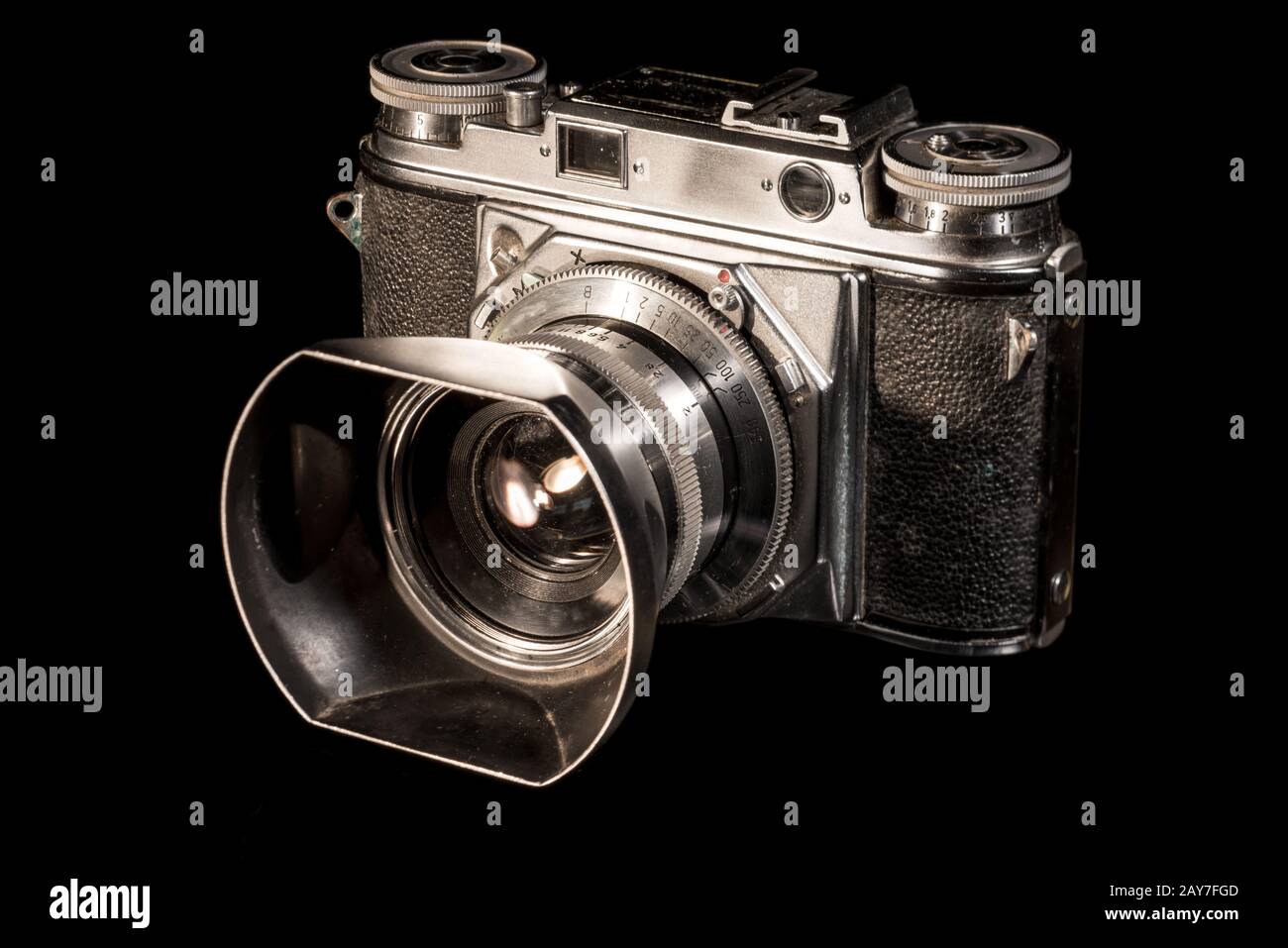 Old photo camera isolated on black Stock Photo - Alamy