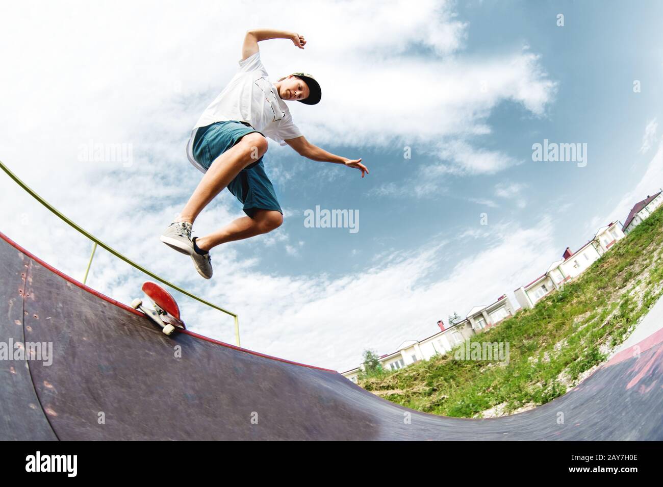 Young skater jumps from ramp down Stock Photo - Alamy