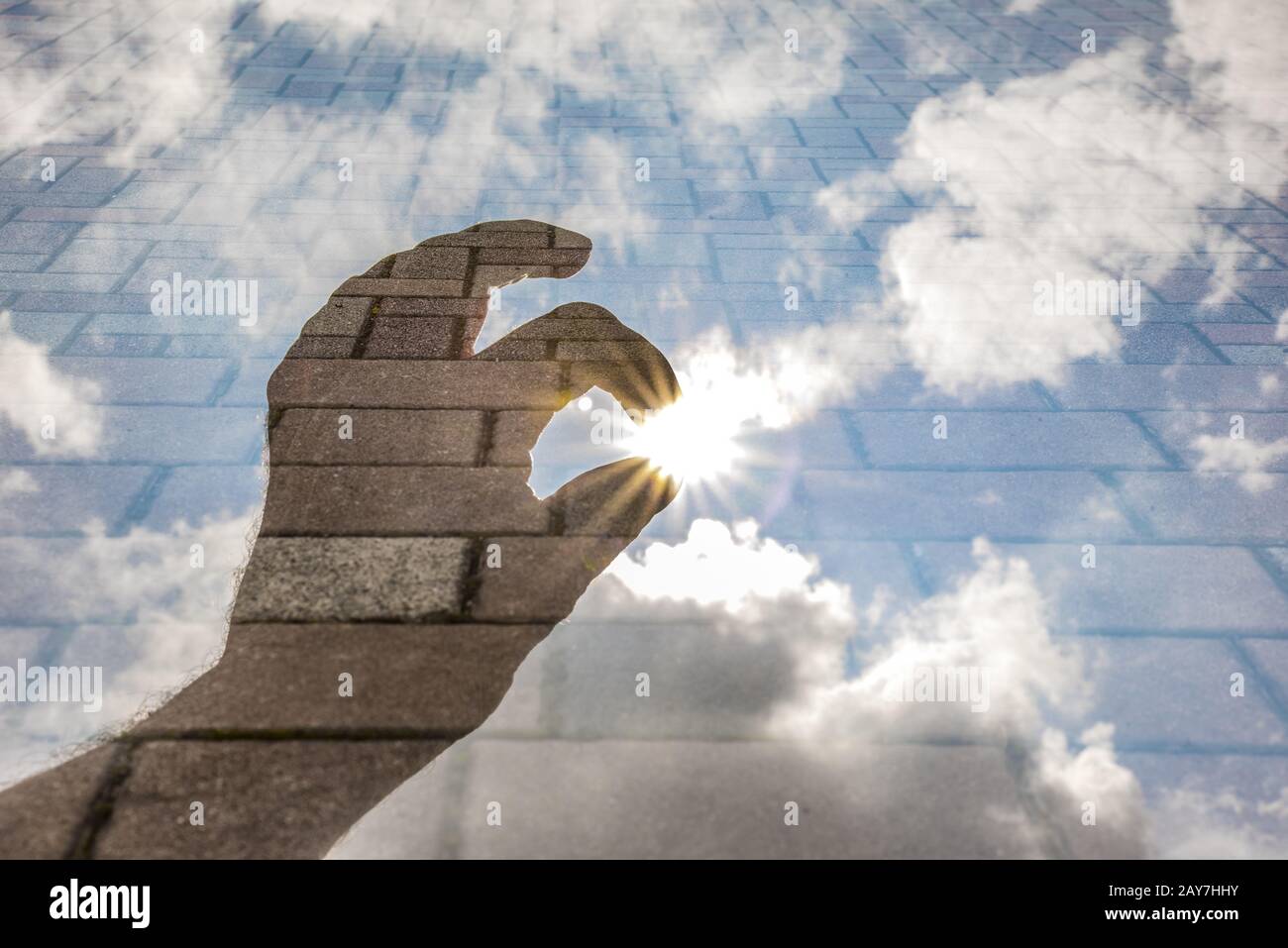 Hand reaching for the sun with paving stones as a background Stock ...