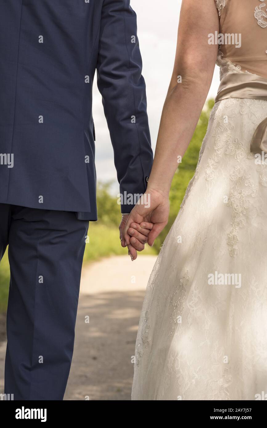 Couple holding hands from behind hi-res stock photography and images ...
