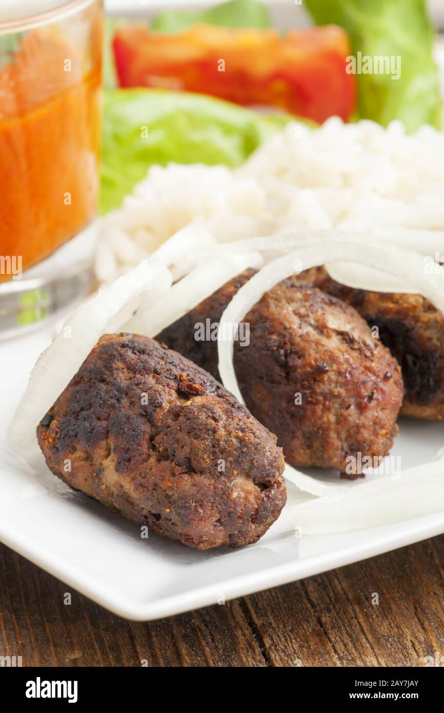 Grilled cevapcici with ajvar Stock Photo - Alamy