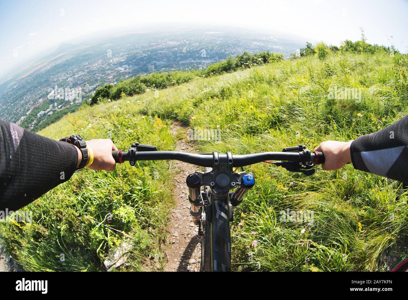 View from the first person of a cyclist riding downhill from a high ...