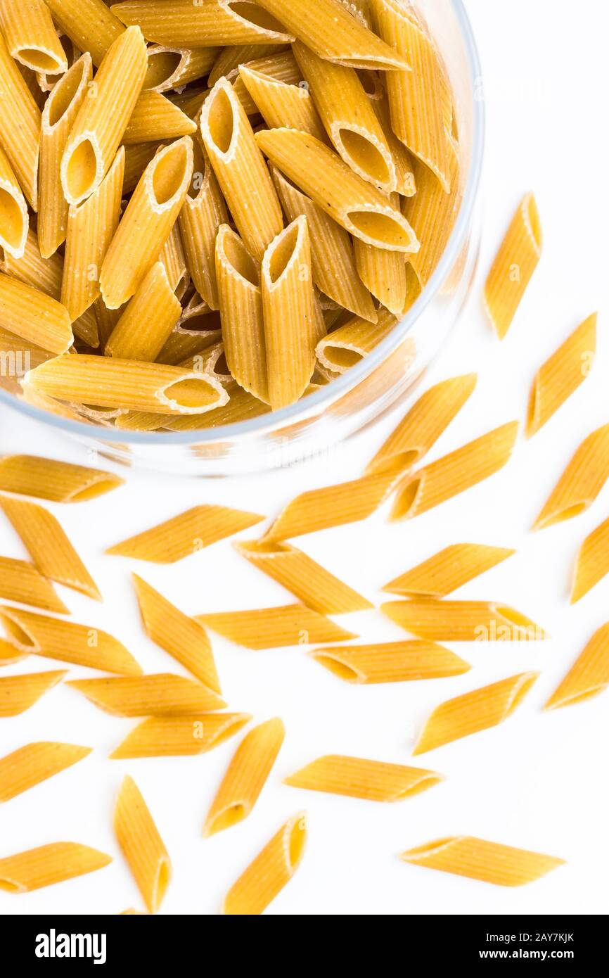 Italian dry pasta in the shape of pens in a glass bowl Stock Photo - Alamy