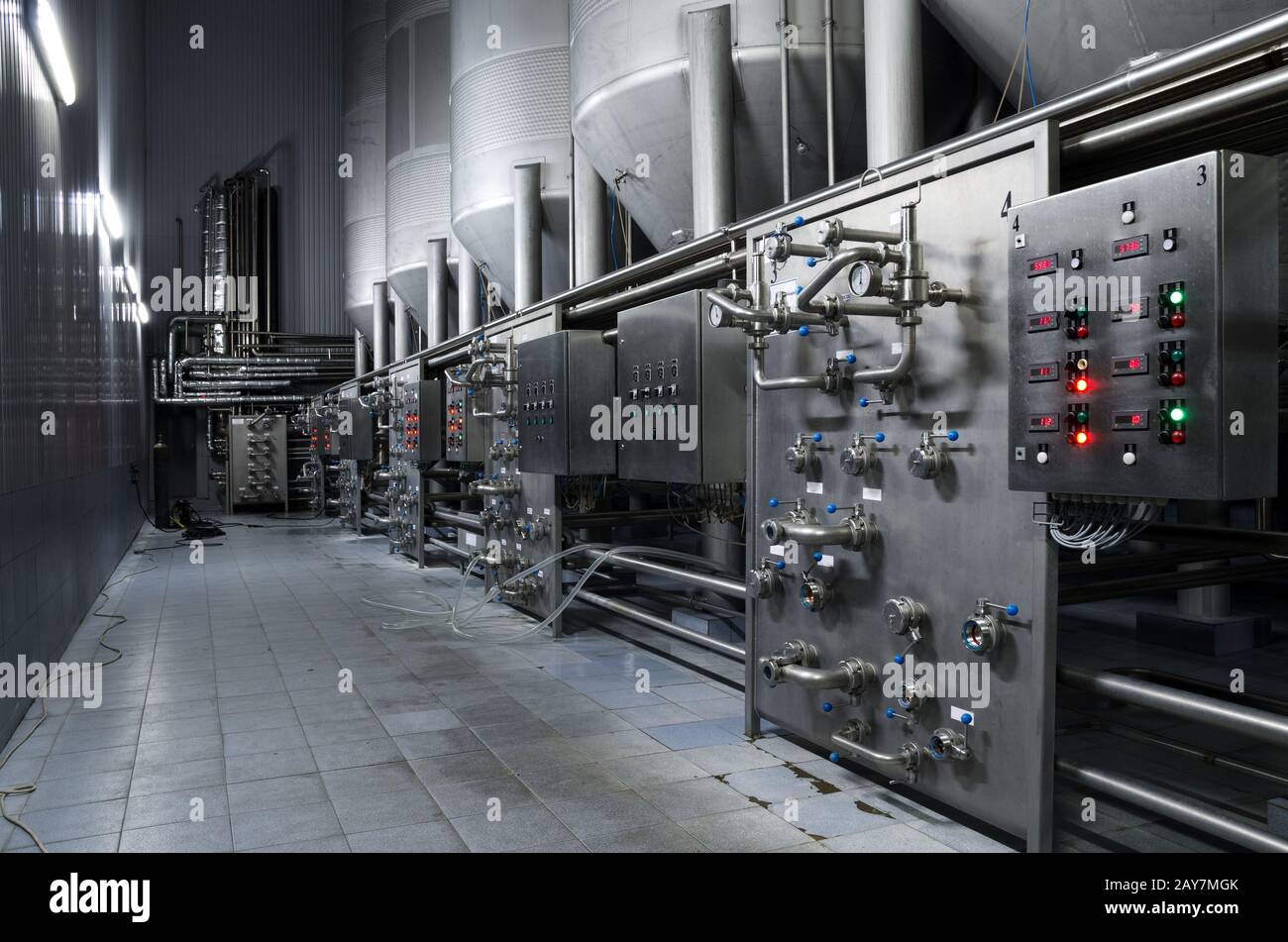Stainless steel tanks for storing beer in a room with a control panel ...