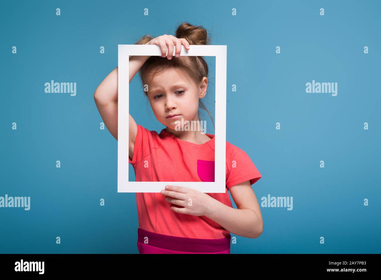 Beautiful cute little girl in pink dress holds picture frame Stock ...