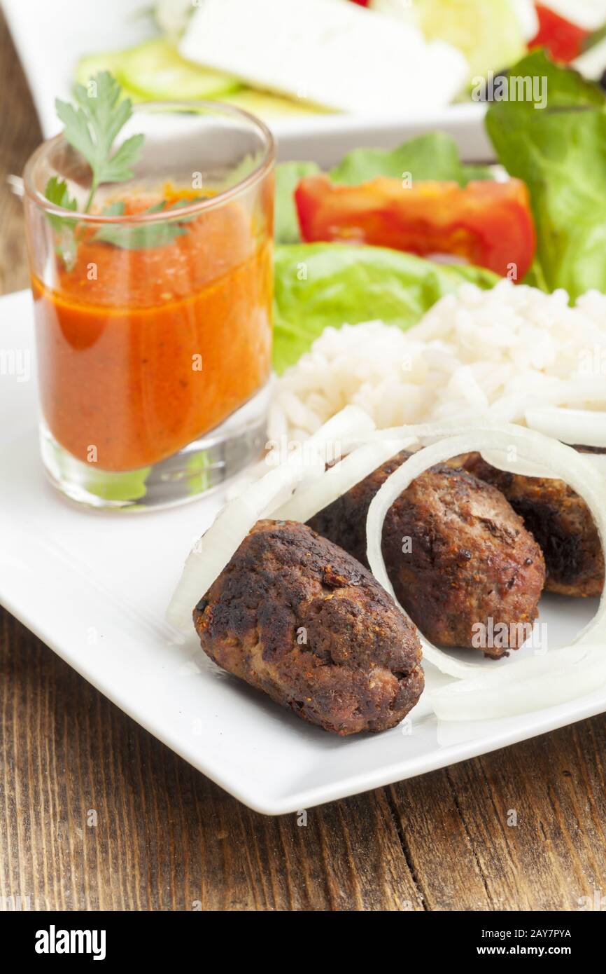 Grilled cevapcici with ajvar Stock Photo - Alamy