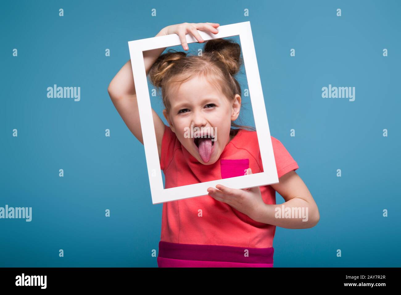 Beautiful cute little girl in pink dress holds picture frame Stock ...