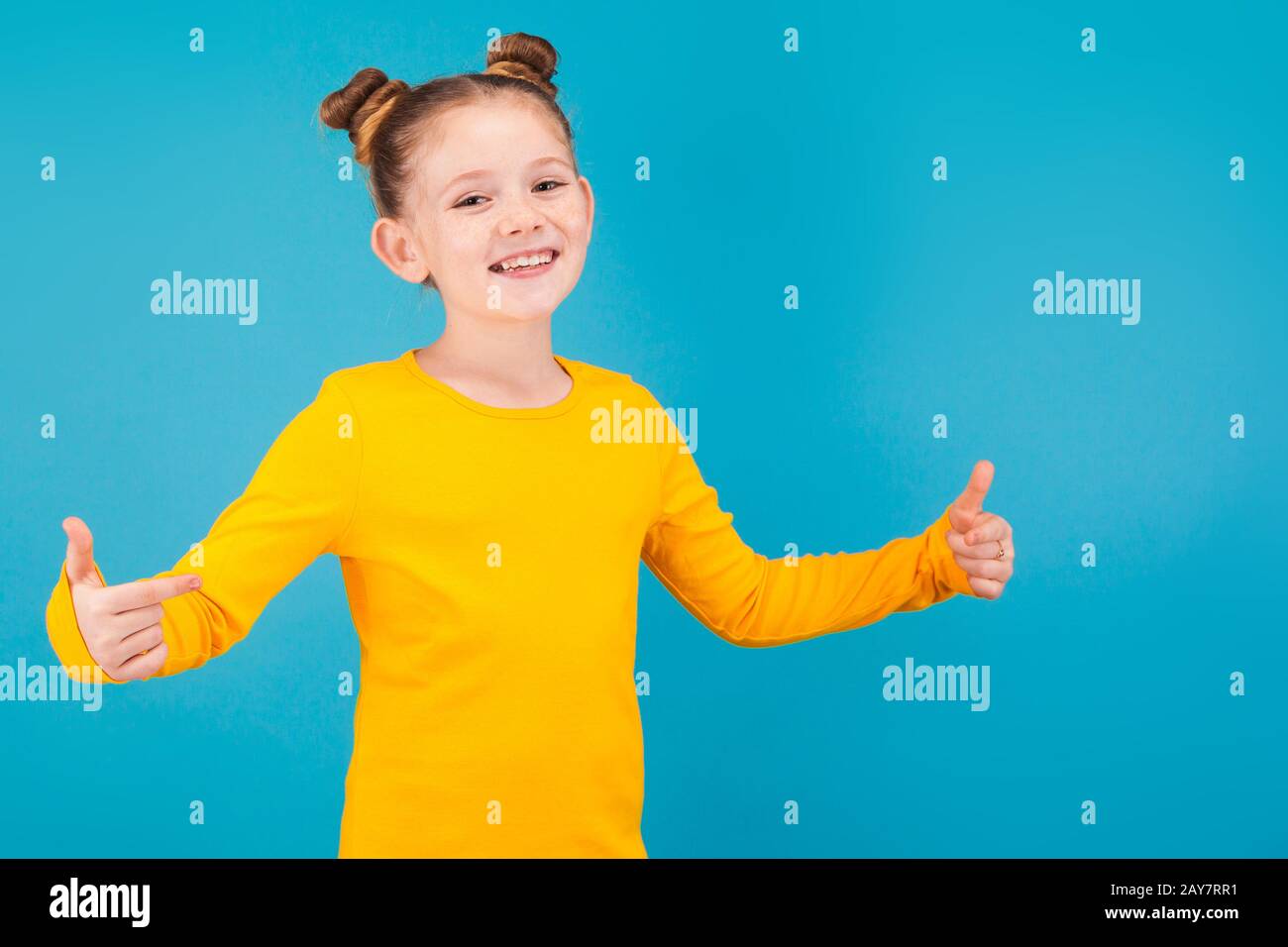 happy little girl on blue background Stock Photo - Alamy