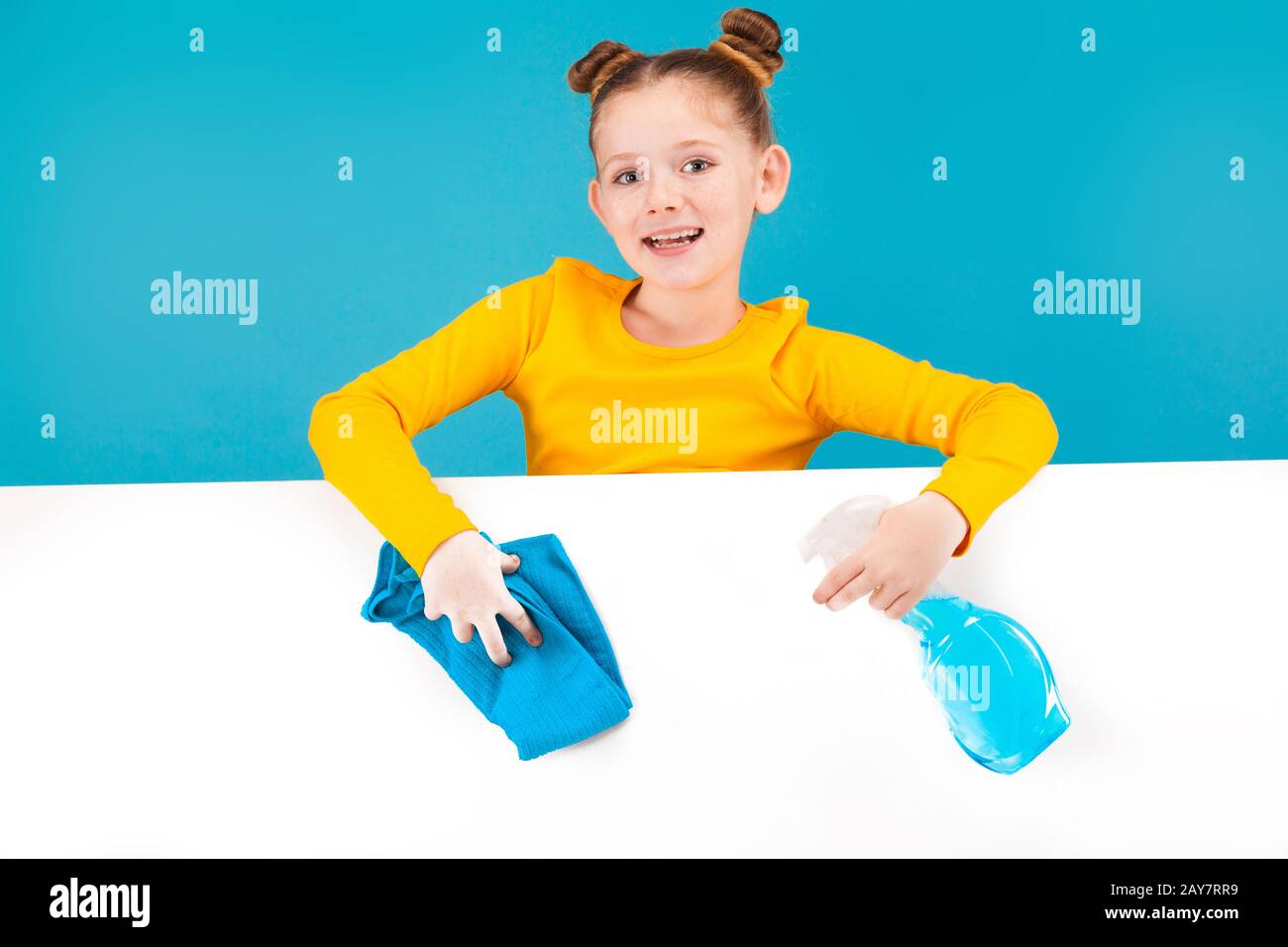 smilng girl with a spray and a blue rag Stock Photo - Alamy