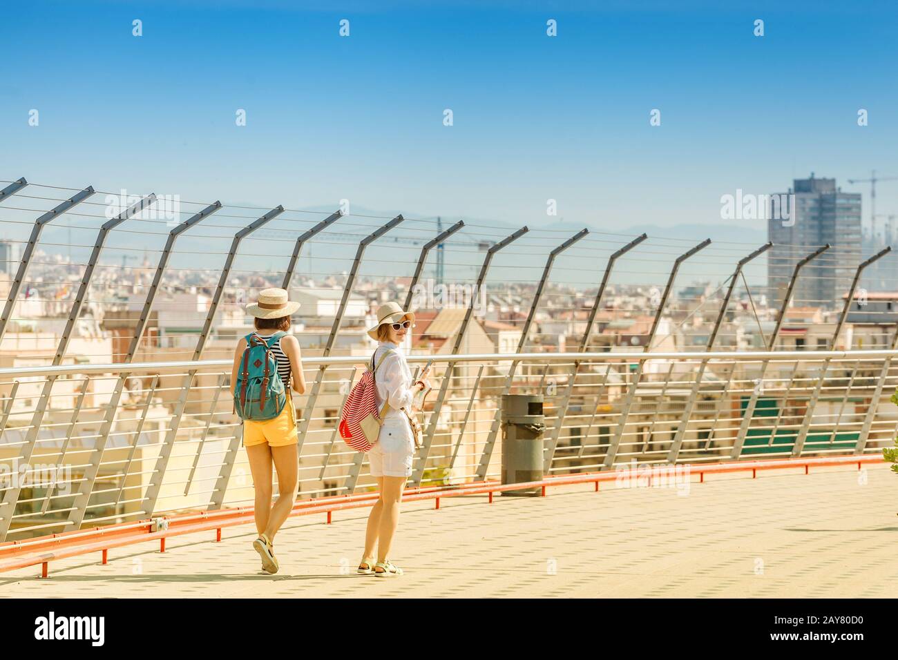 Happy girls enjoying a beautiful view in Barcelona at hot summer day ...