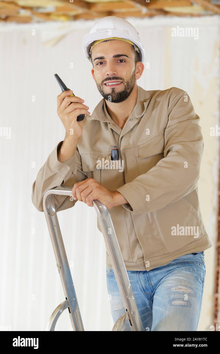 builder talking on portable uhf radio transceiver Stock Photo - Alamy