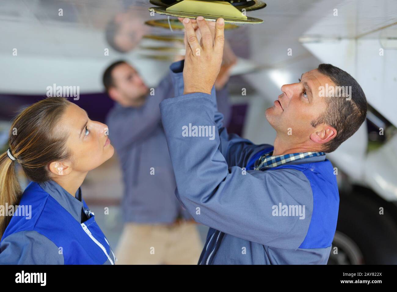 happy female mechanic fixing an airplane Stock Photo - Alamy