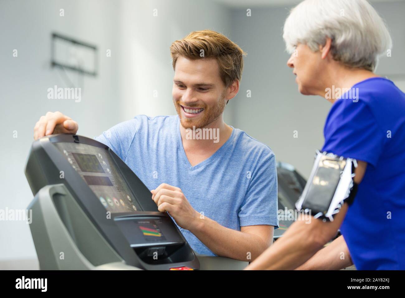 young coach with senior female at the gym Stock Photo - Alamy