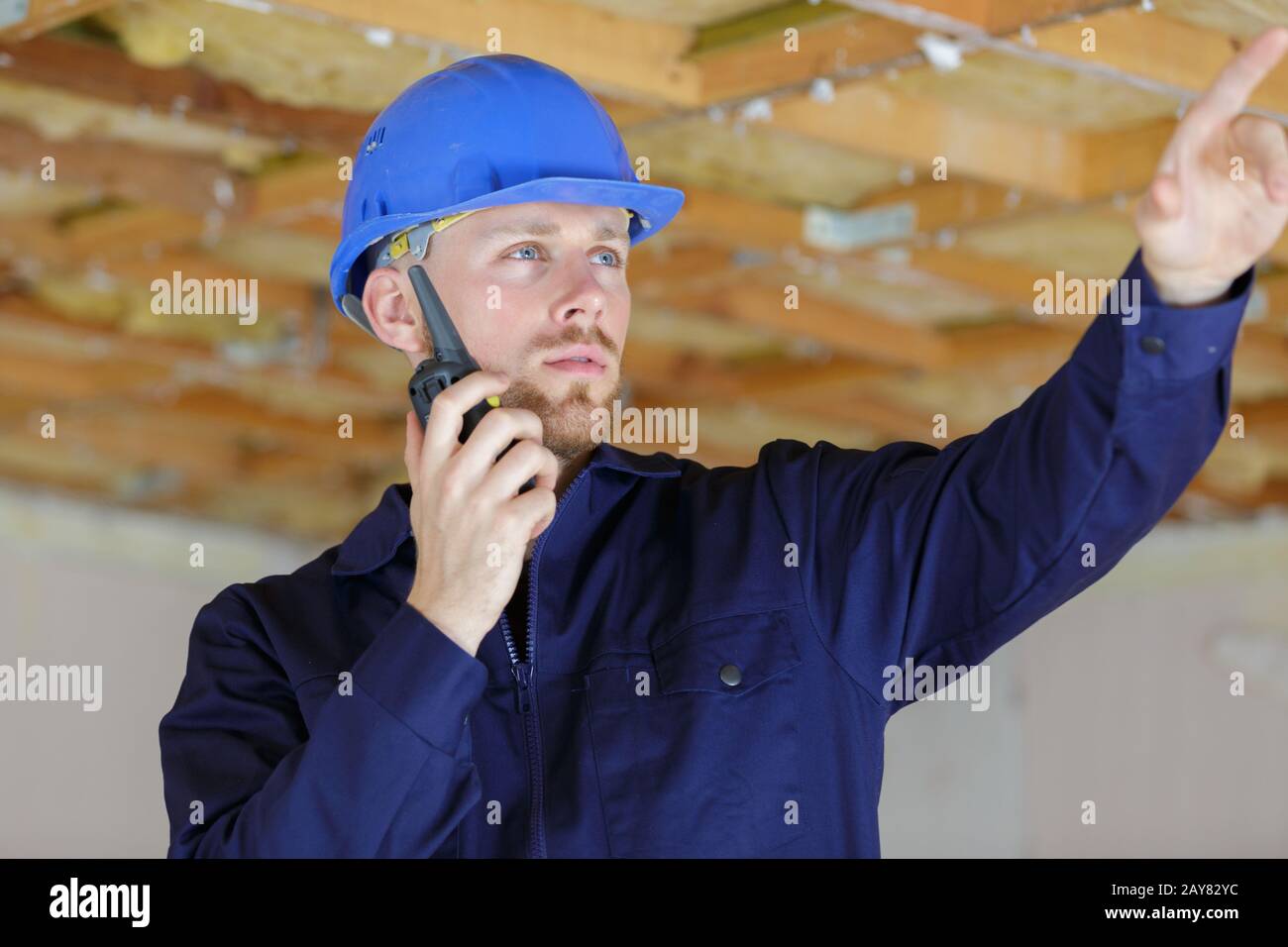 electrician uses a walkie talkie to communicate with team Stock Photo ...