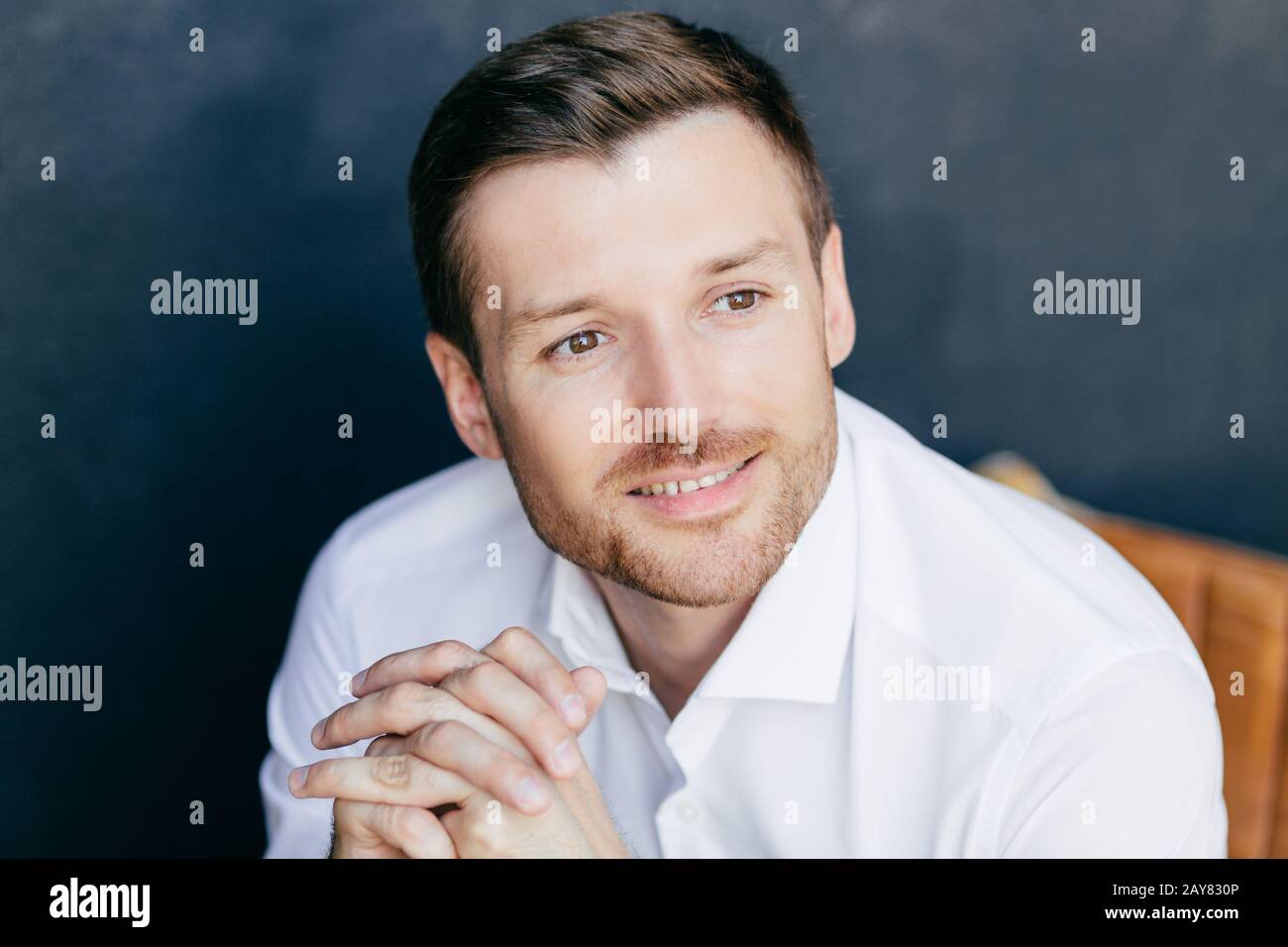 Photo of cheerful pensive young male with bristle, dreams about ...