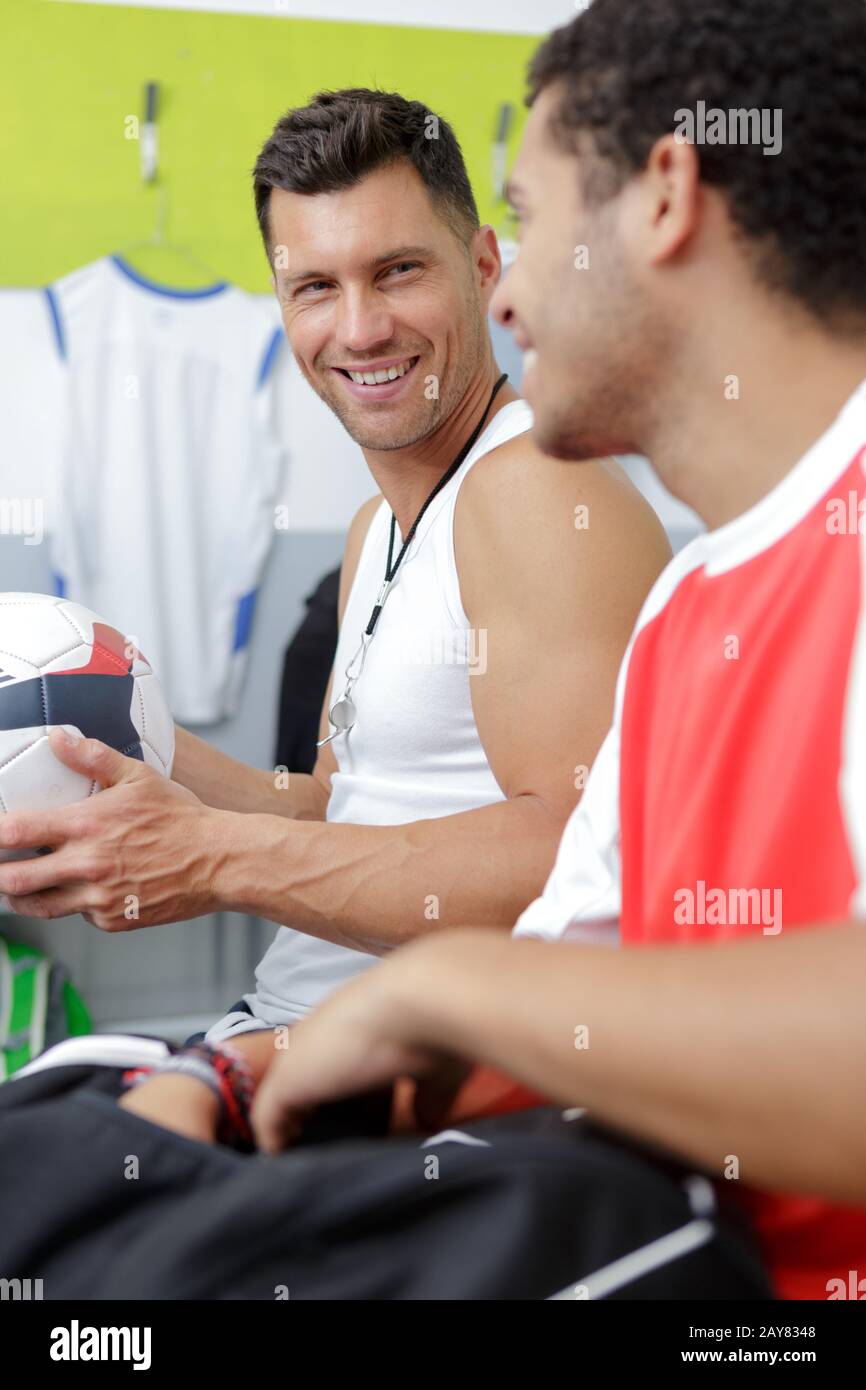 coach and sportsman in locker-room Stock Photo - Alamy