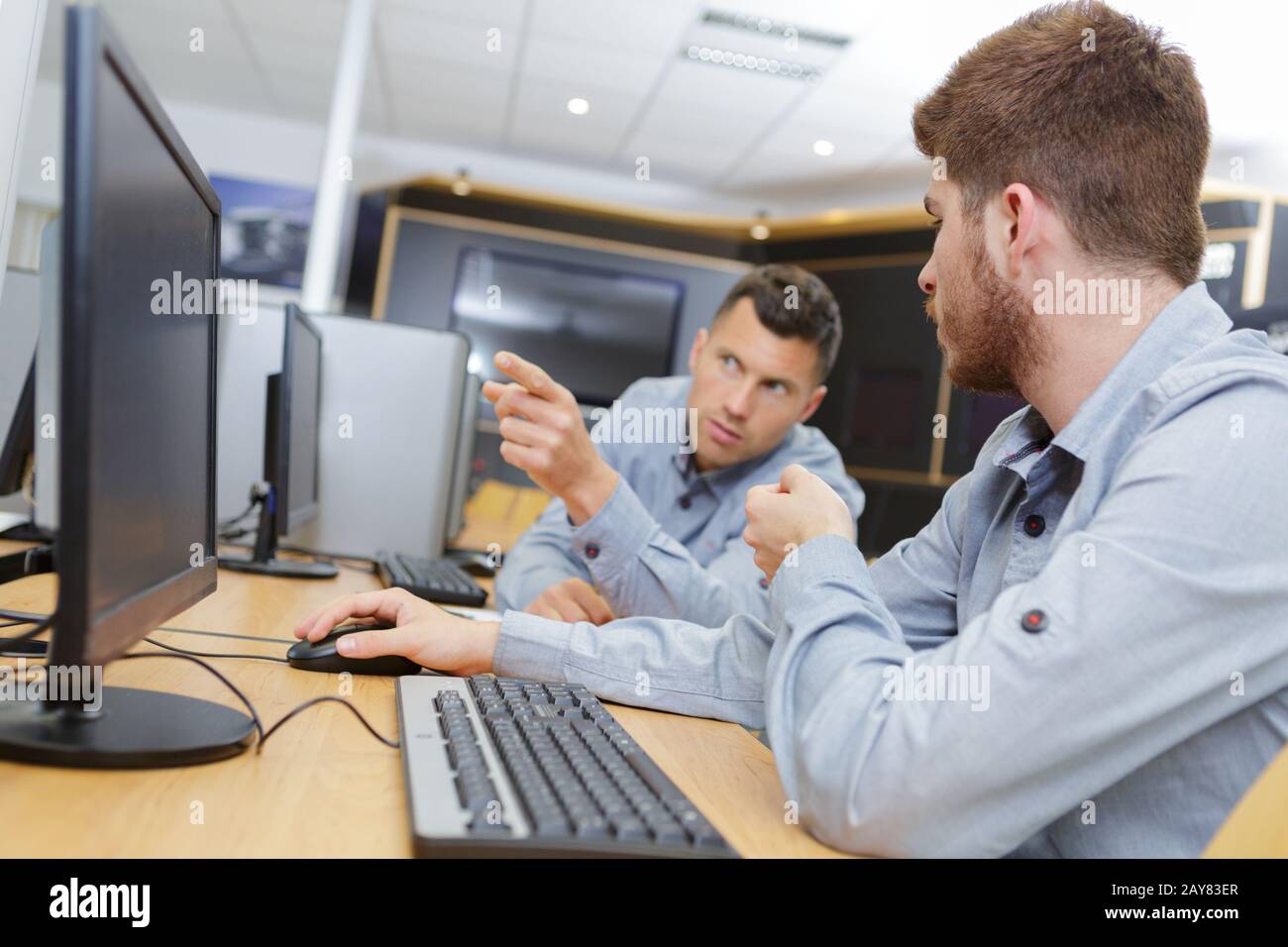portrait of workers next to pc Stock Photo - Alamy