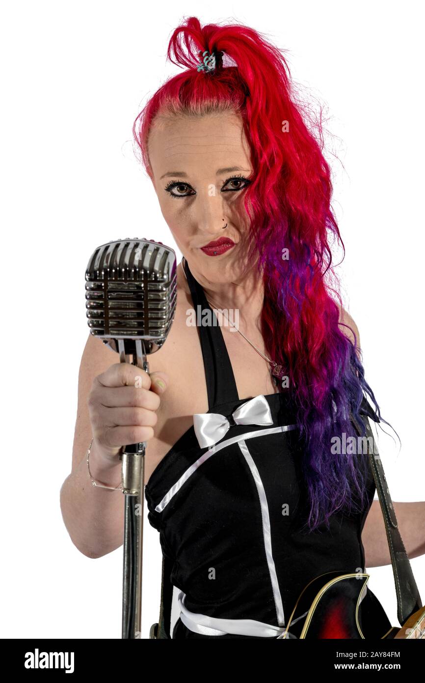 Rock'n'Roll singer with red hair, guitar and microphone Stock Photo - Alamy