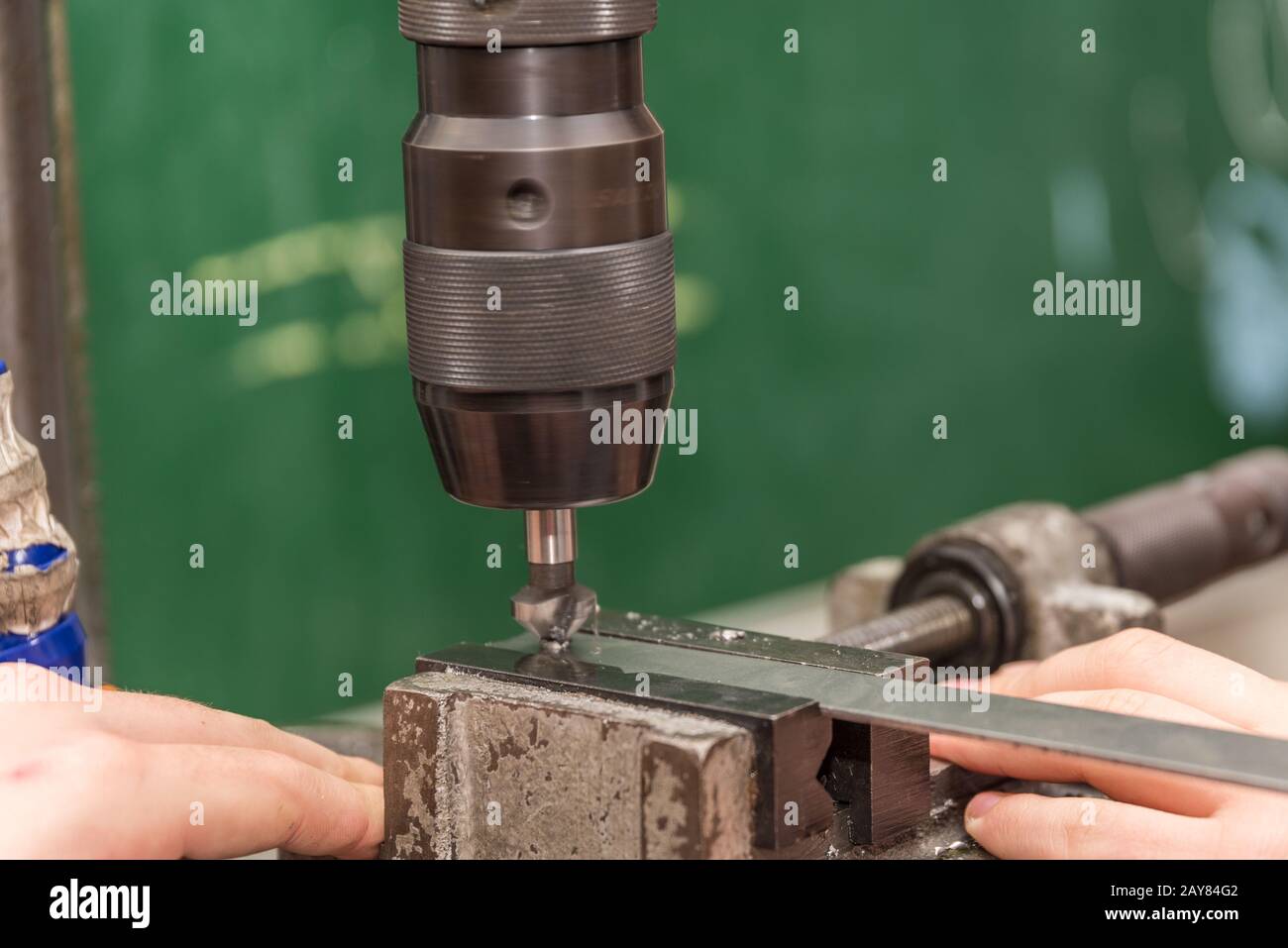 Drill into metal piece with a counterbore drill - close-up counterbore ...