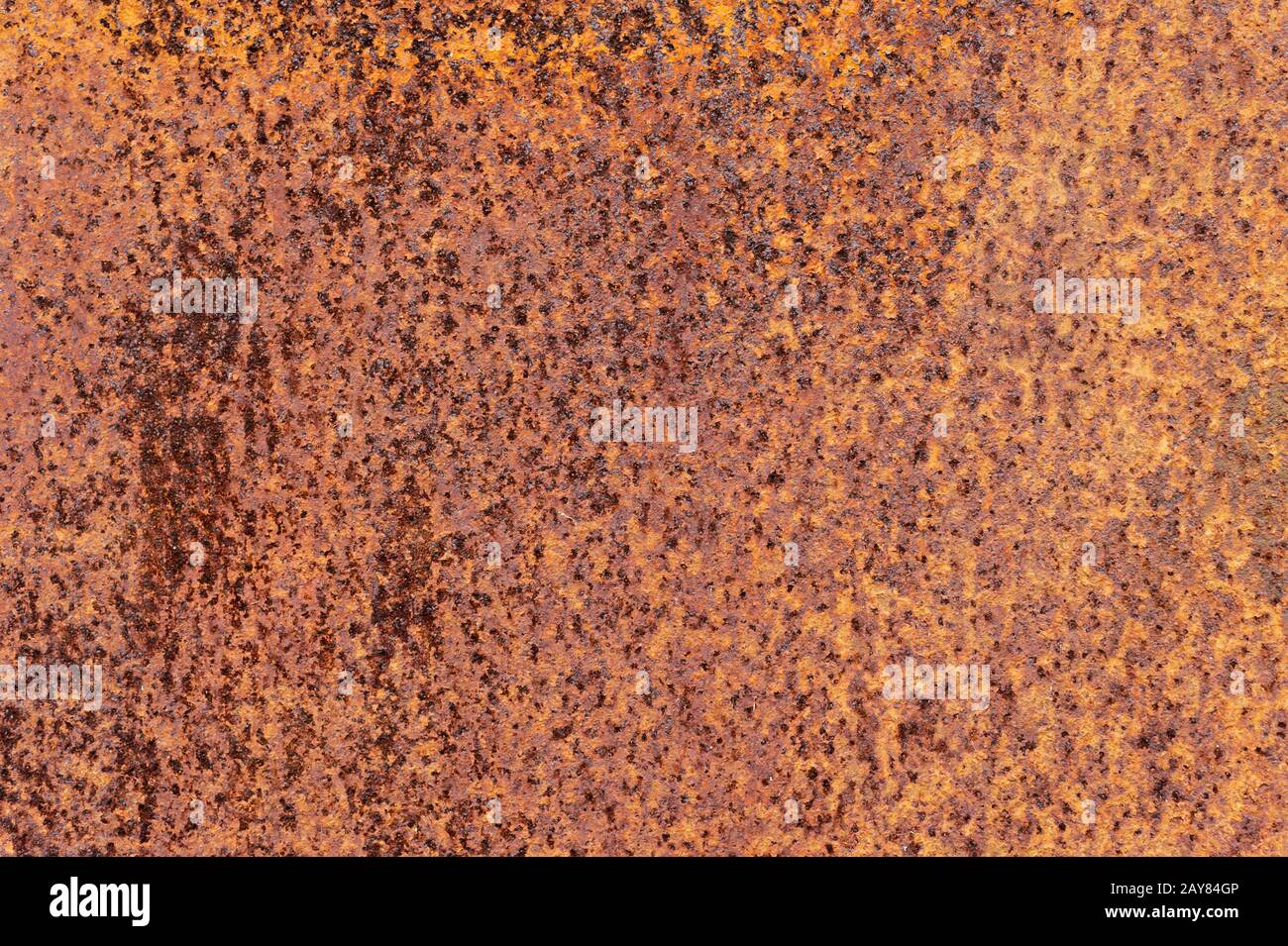 Rusty yellow-red textured metal surface. The texture of the metal sheet ...