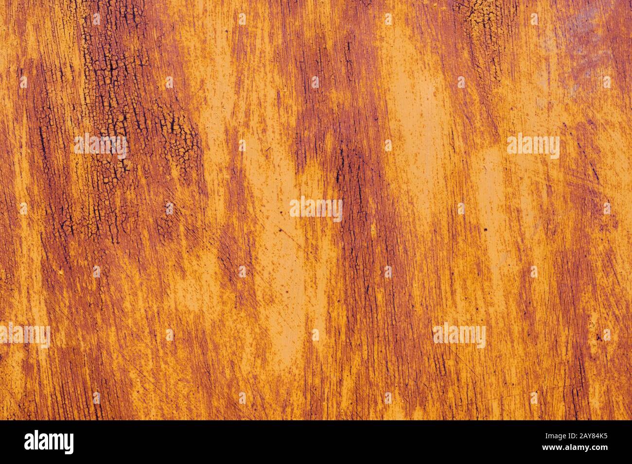 Textured background of a faded yellow paint with rusted cracks on ...
