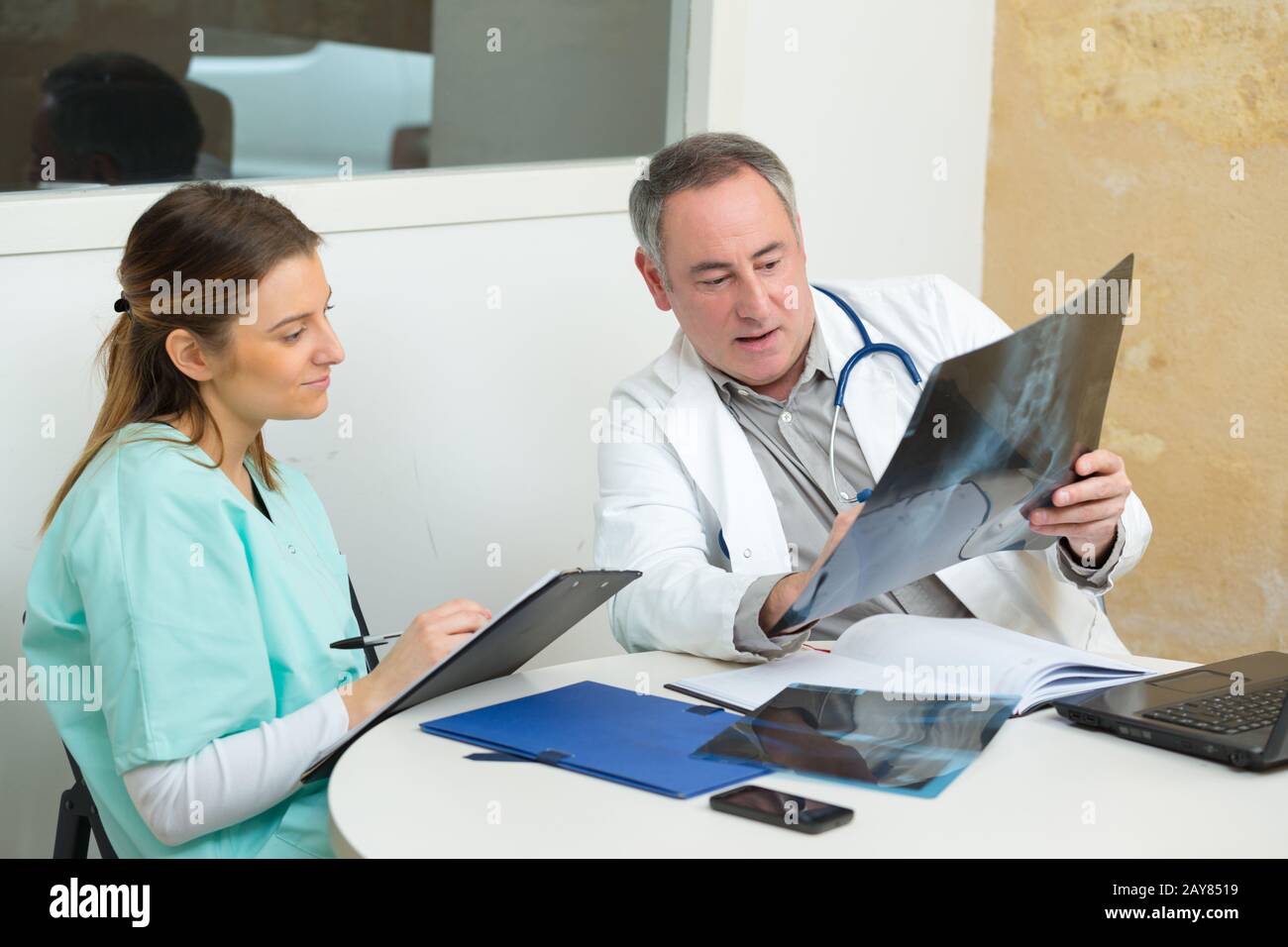 intern taking notes on xray result Stock Photo - Alamy