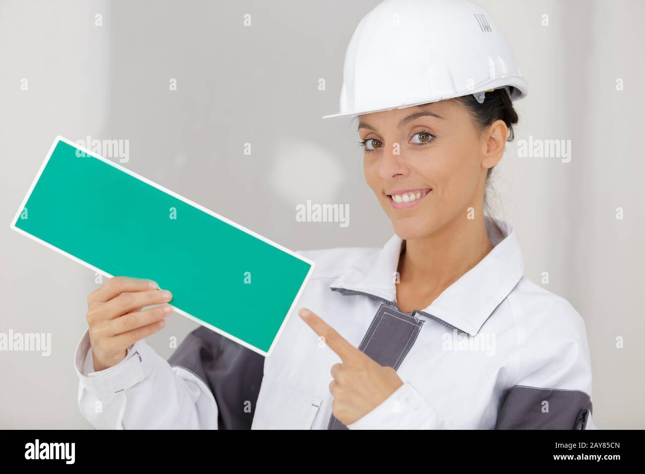 woman painter holding wet paint sign Stock Photo - Alamy