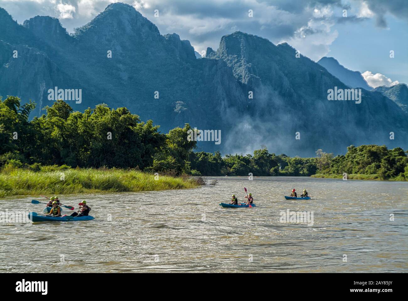 Tourists kayaking and tubing on the Nam Song river at Vang Vieng, Laos ...
