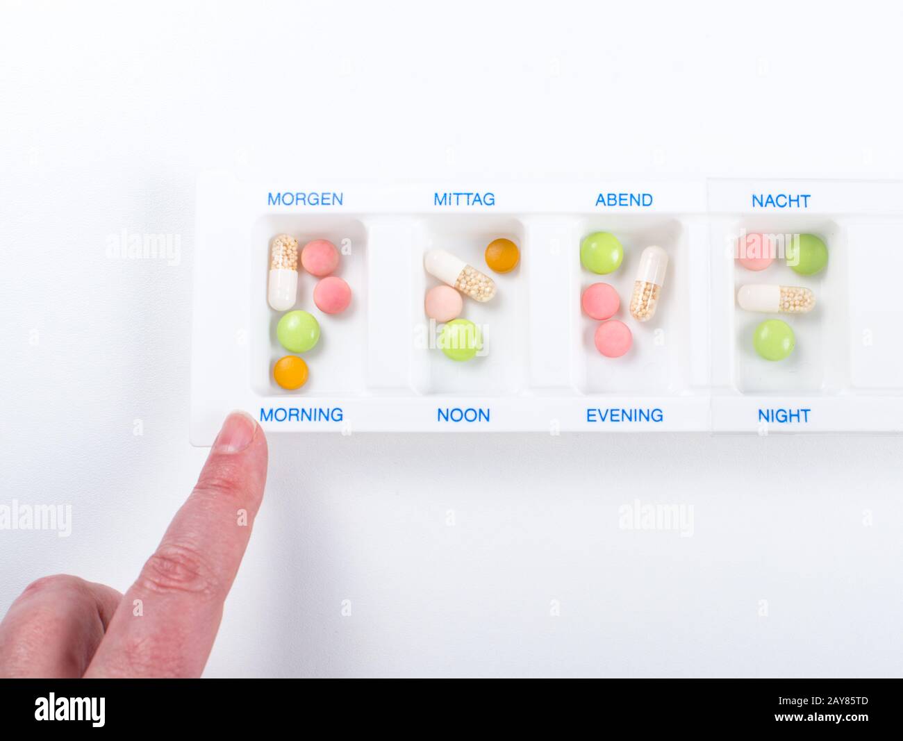 Taking medication on white background Stock Photo - Alamy