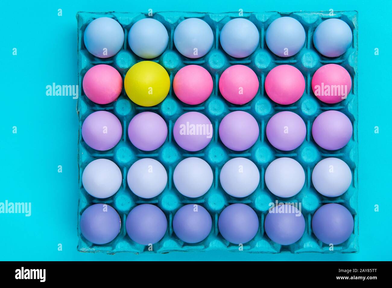 Vibrant shades of painted eggs in tray Stock Photo - Alamy