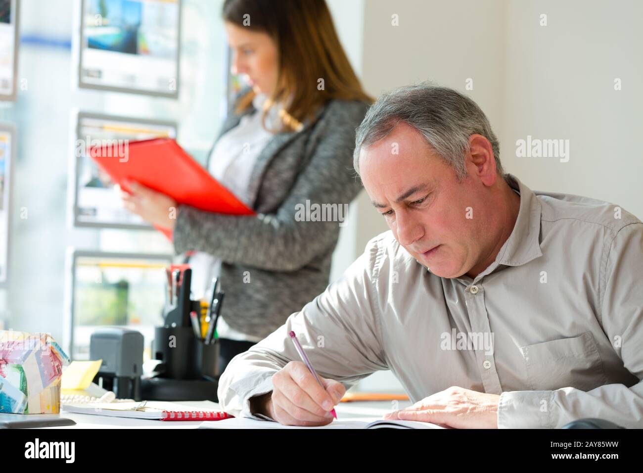 serious employee is reviewing documents Stock Photo - Alamy