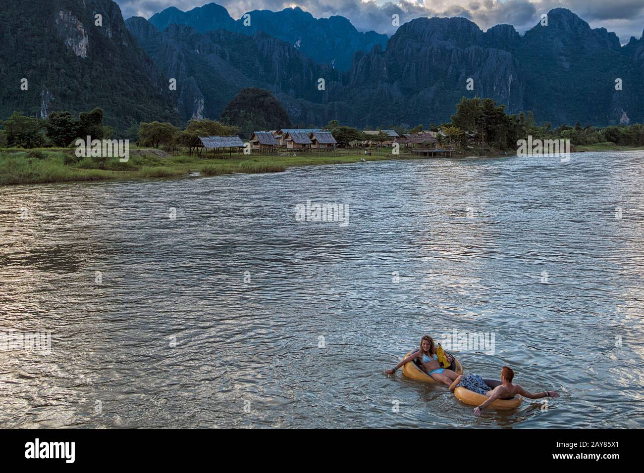 Tourists kayaking and tubing on the Nam Song river at Vang Vieng, Laos ...