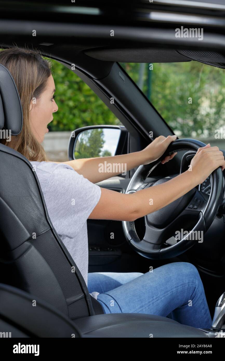 young shocked woman while driving car Stock Photo - Alamy