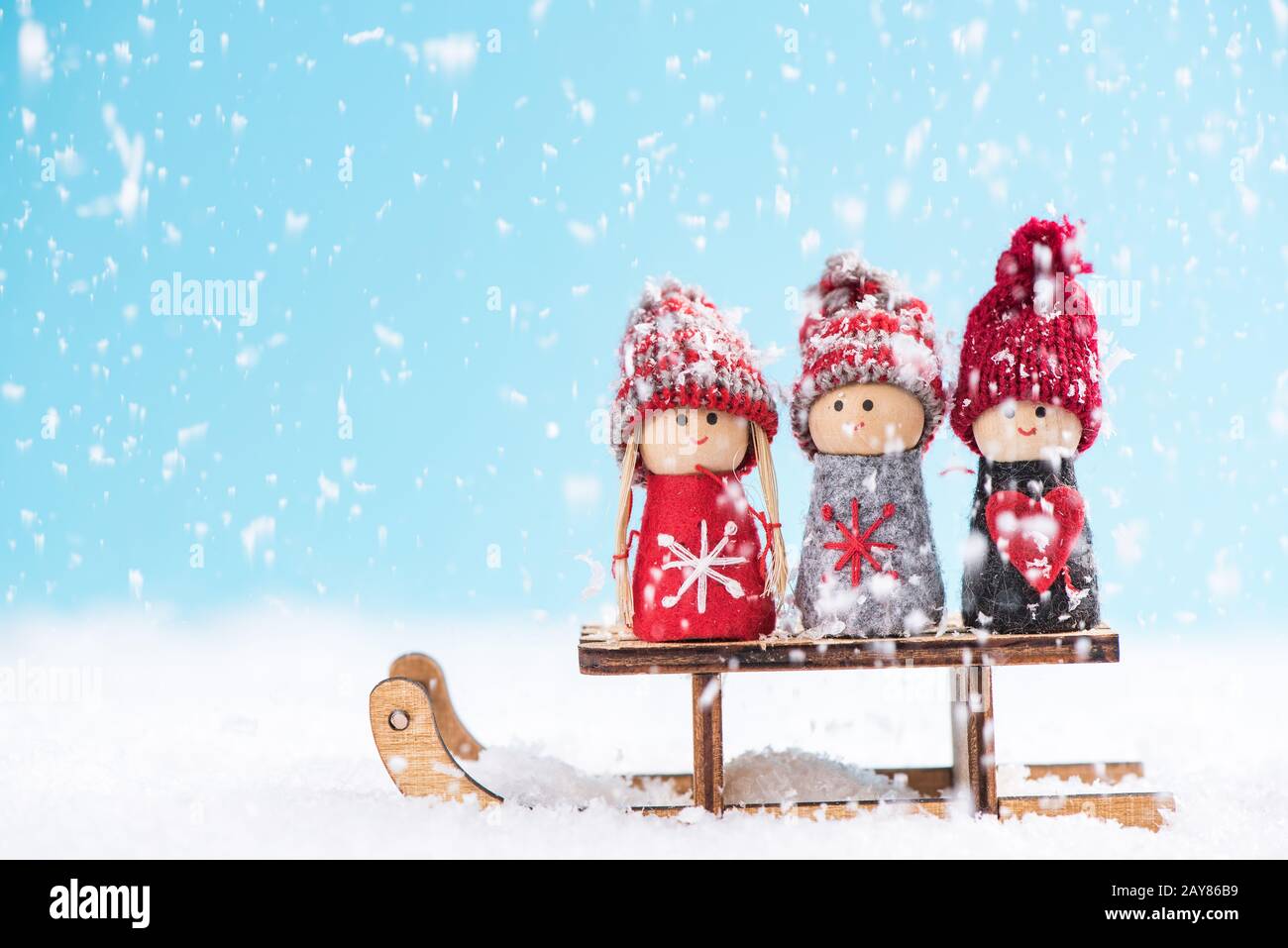 Happy and funny kids on snow sledge Stock Photo - Alamy
