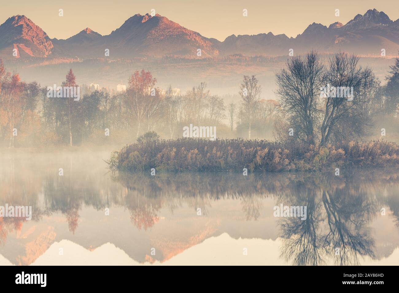 Stunning high peak reflection in lake and autumn foliage Stock Photo ...