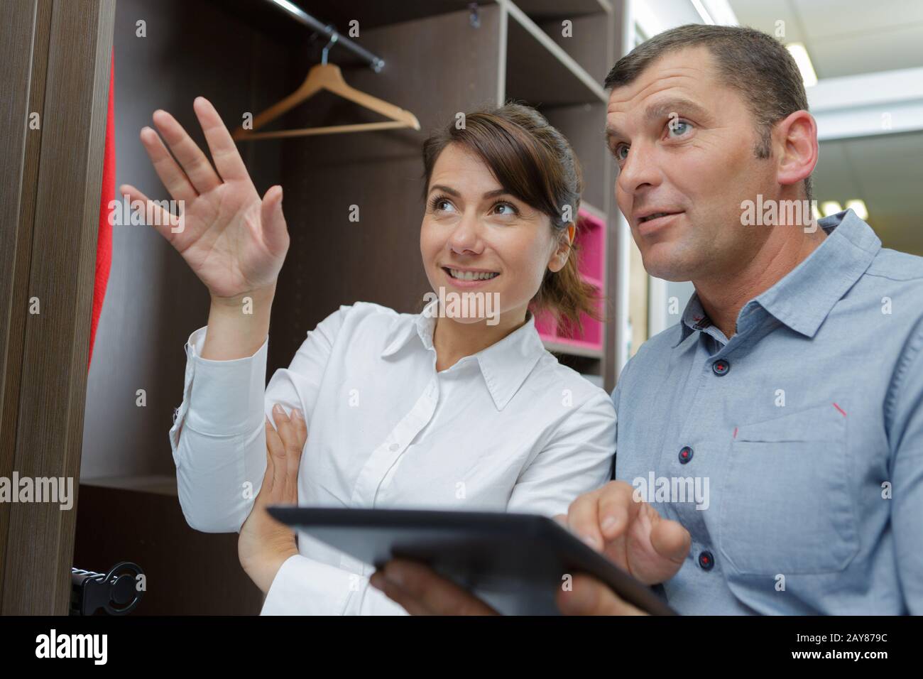 couple checking something in store Stock Photo - Alamy