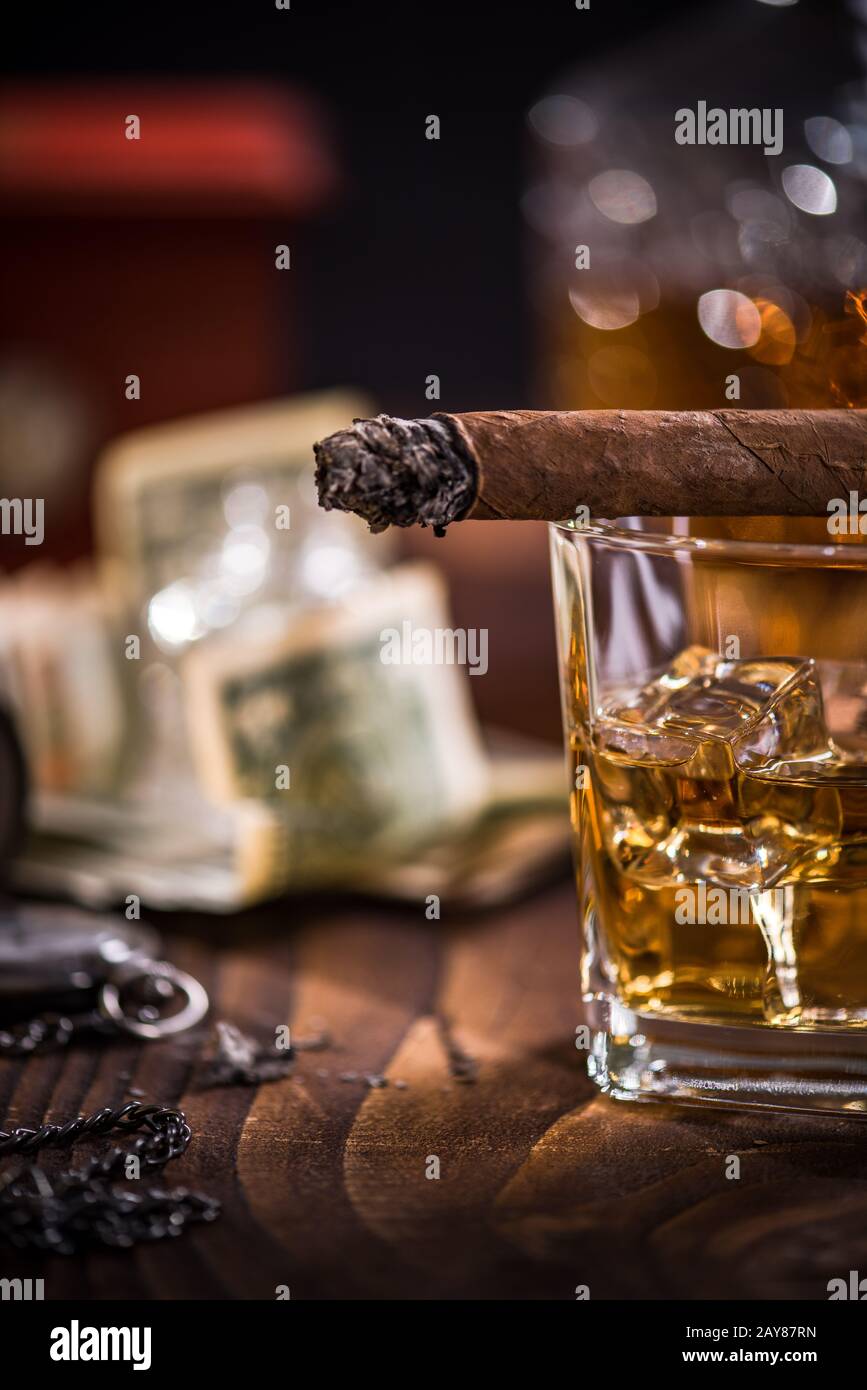 Cuban cigar and cognac over ice cubes Stock Photo - Alamy