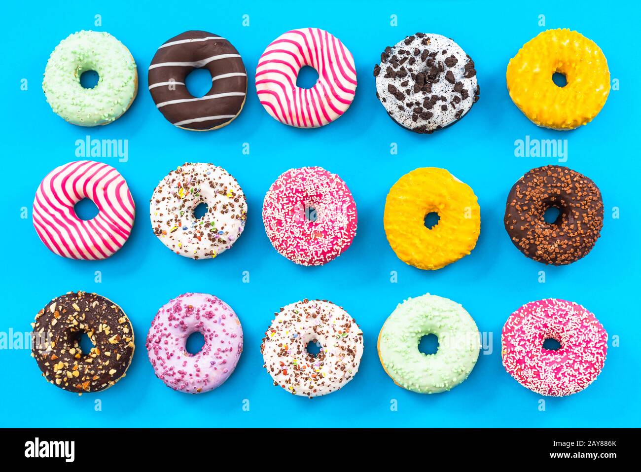 Colorful donuts border background, top view flat lay Stock Photo - Alamy